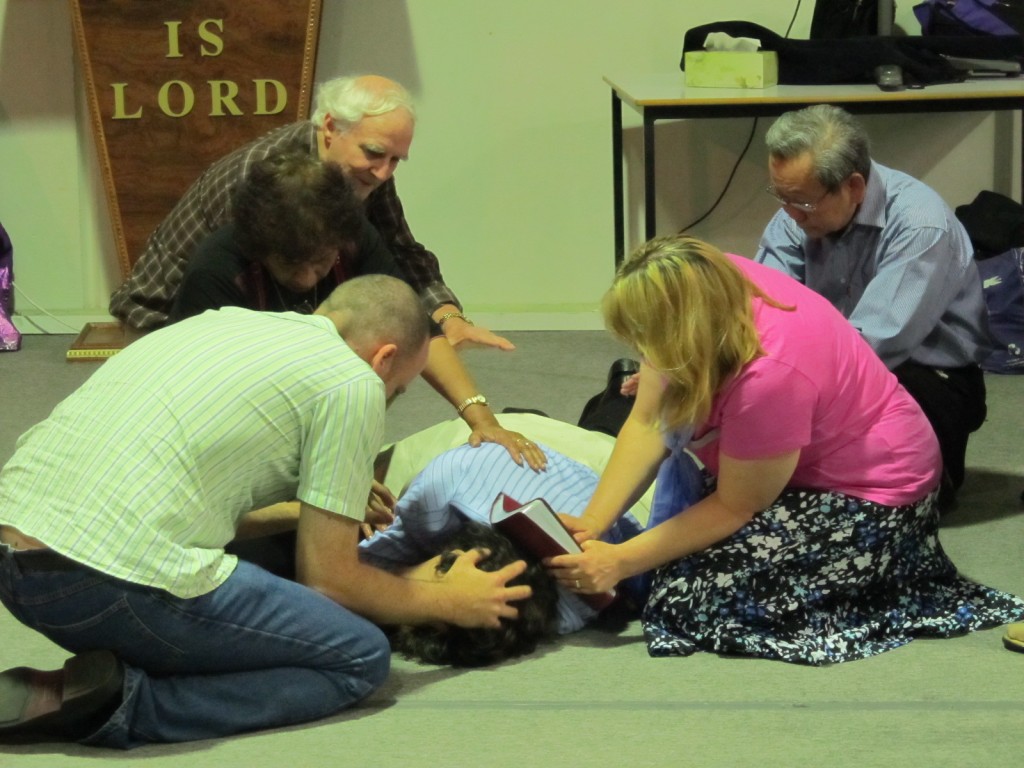 Young man being set free from demons at Reformation Harvest Fire Ministries