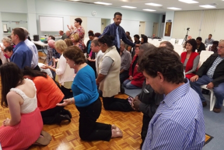 Ministering to people at the altar – Reformation Harvest Fire Ministries